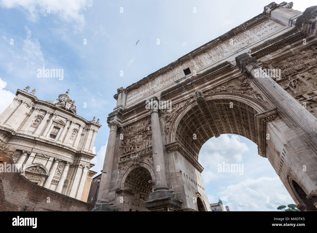 Wide angle picture of amazing architecture of Arch of Titus and church ...