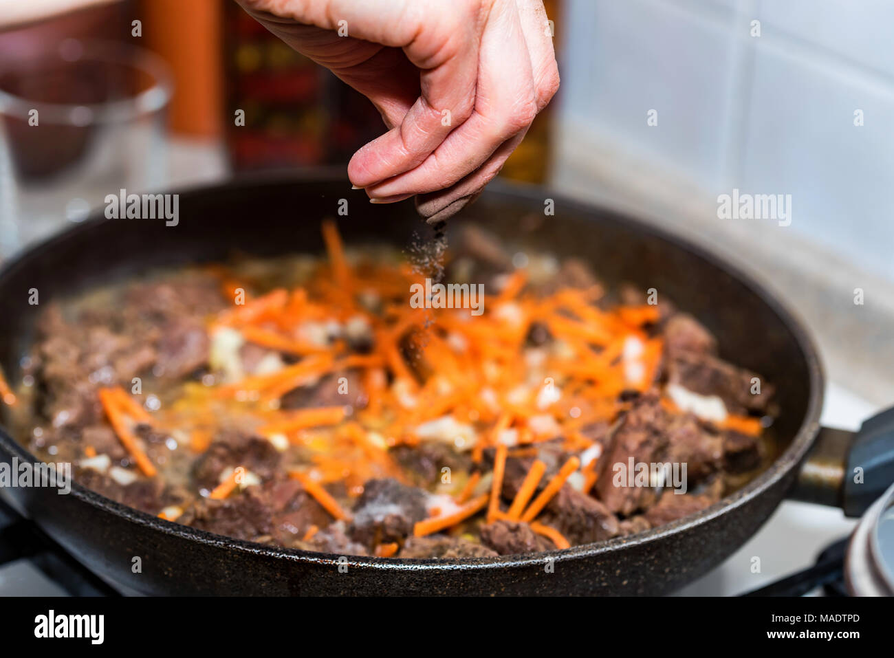 Hand adding salt hi-res stock photography and images - Alamy