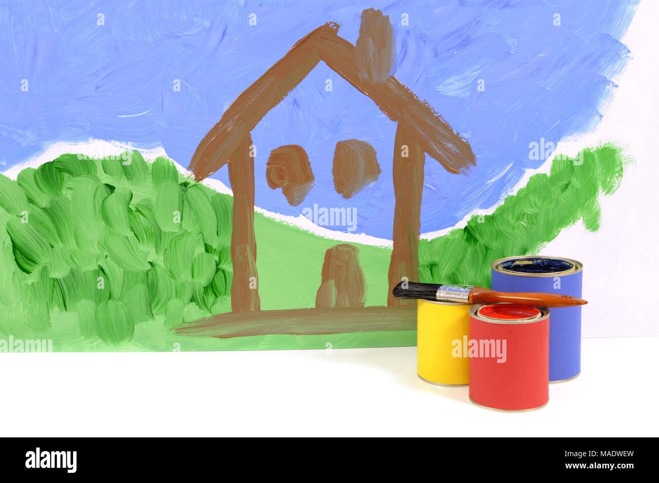 Home decorating concept with partly painted house scene on a white wall ...