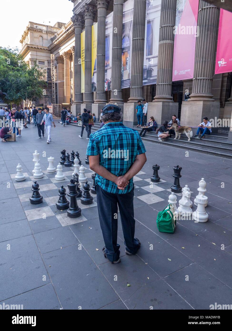 People playing chess on big pavement chess boards in front of the State ...