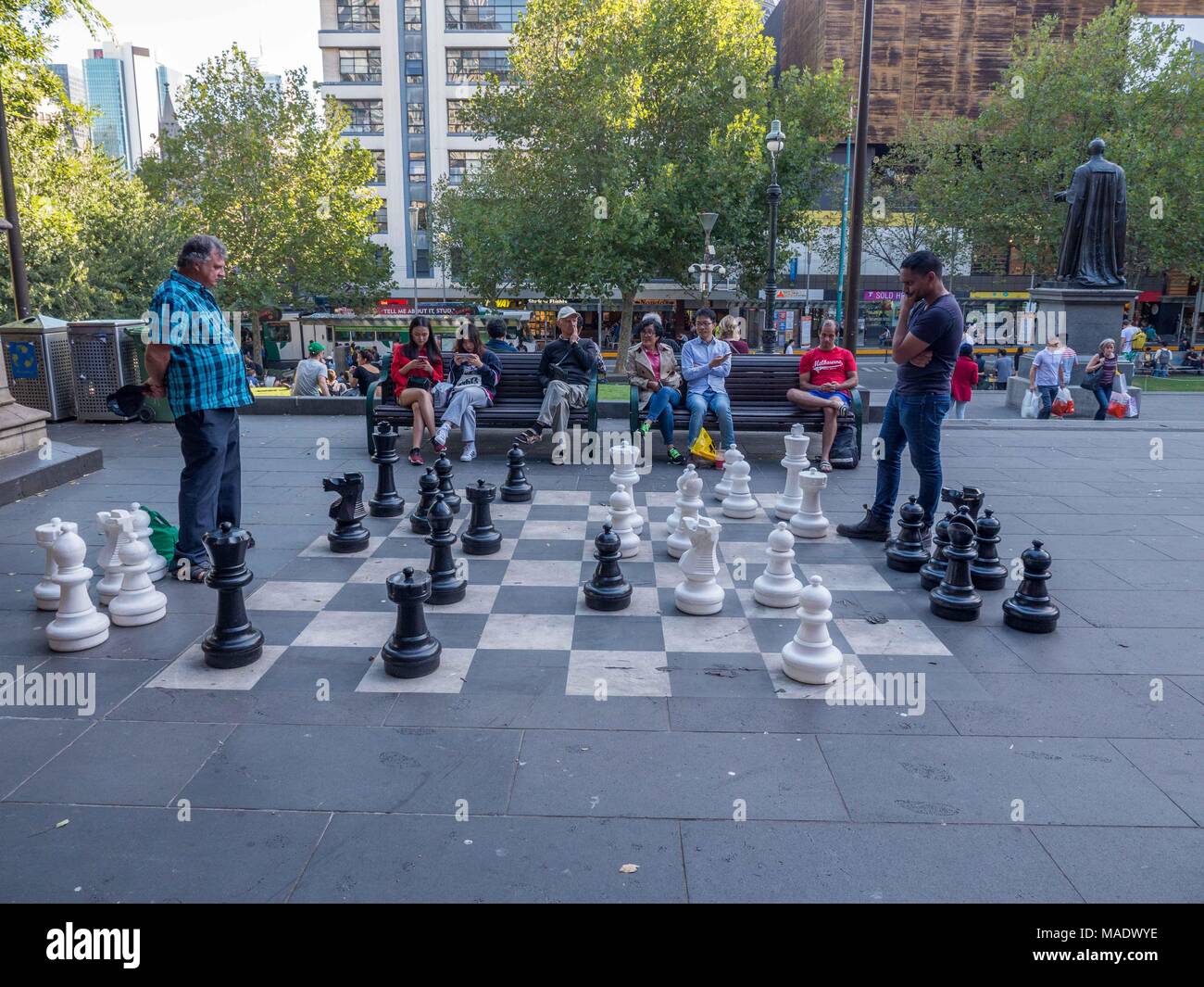 People playing chess on big pavement chess boards in front of the State ...