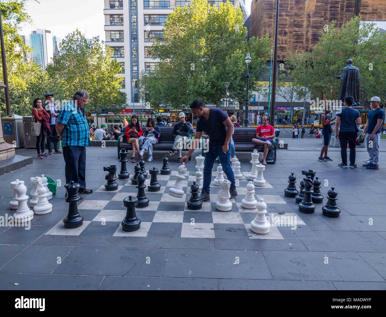People playing chess on big pavement chess boards in front of the State ...