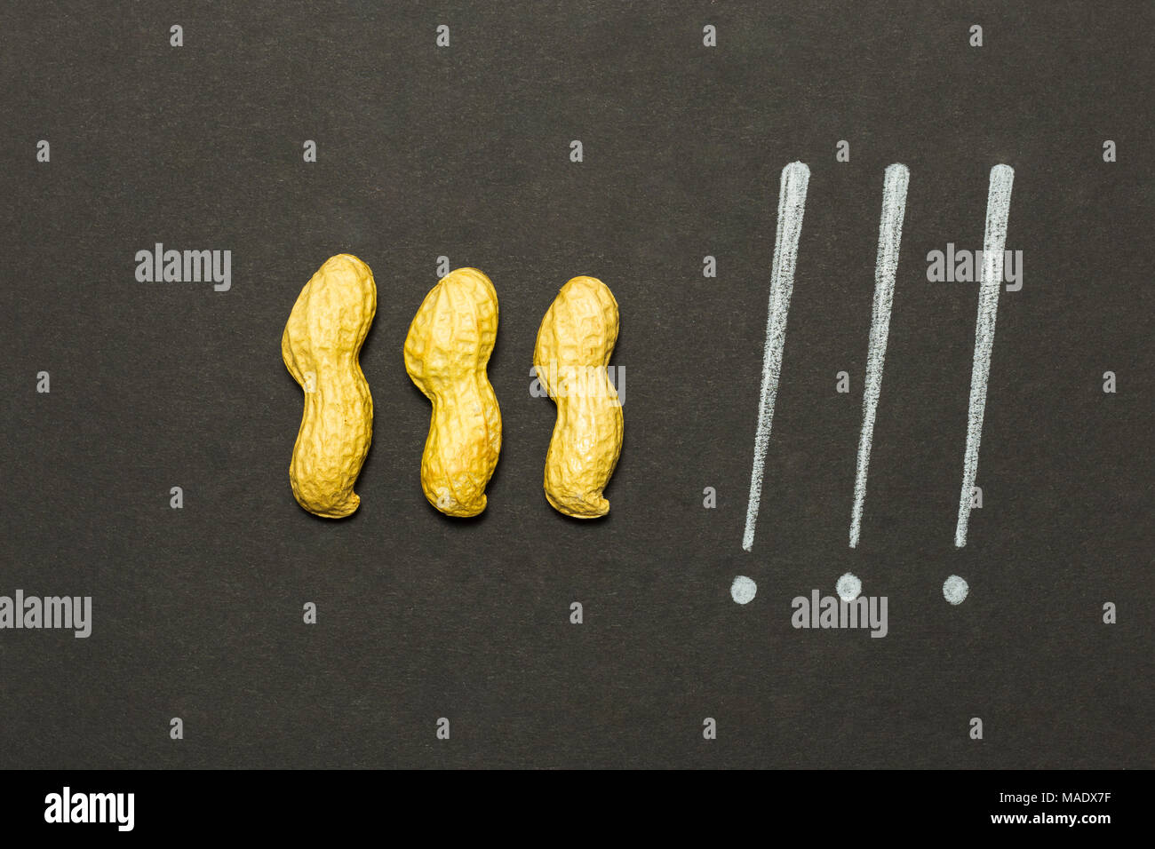 Concept of the saying that's peanuts! Raw unpeeled peanuts and white ...