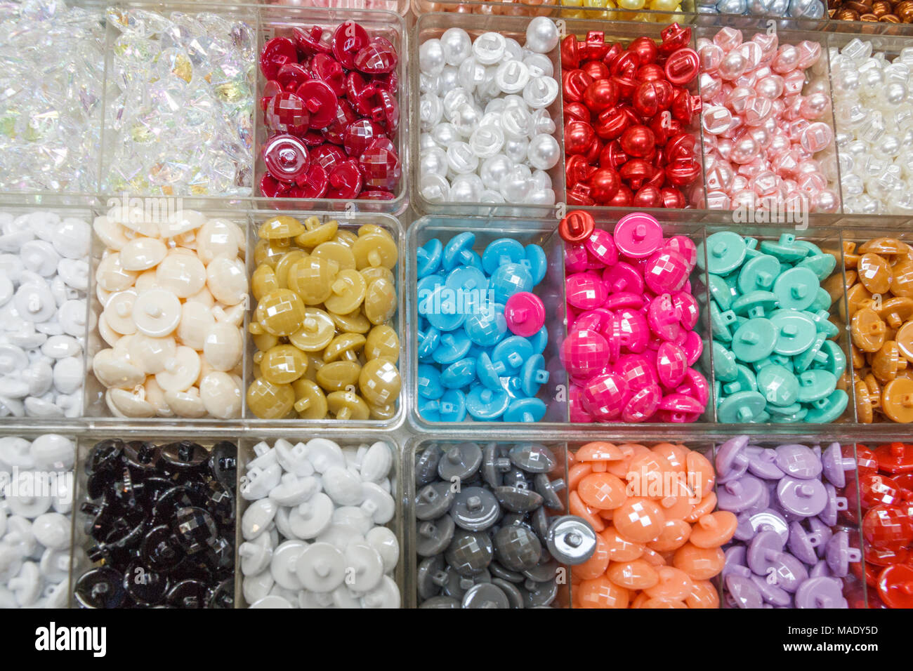 Trays of coloured buttons hi-res stock photography and images - Alamy
