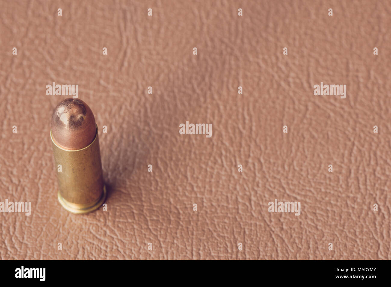 bullets on brown leather Stock Photo - Alamy