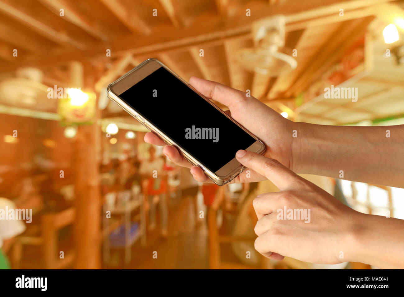 Woman Hand holding smartphone with Geometry symbol in the restaurant ...
