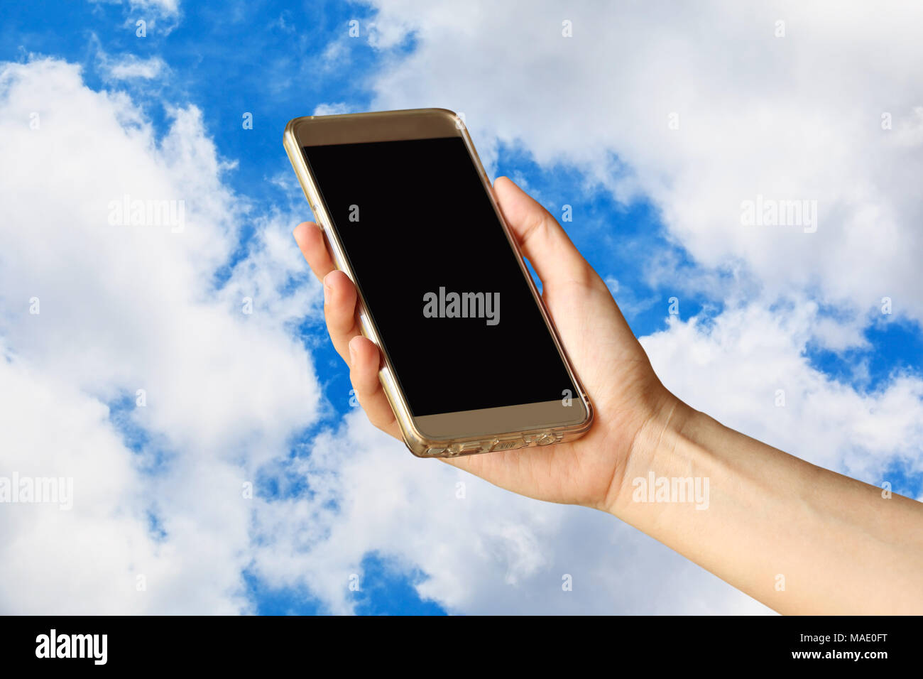woman hand hold smartphone, tablet,cell phone on blue sky background ...