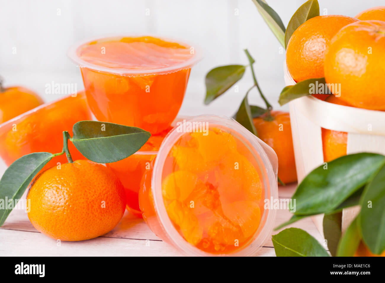 Plastic containers with mandarine tengerine jelly with fresh fruits in ...
