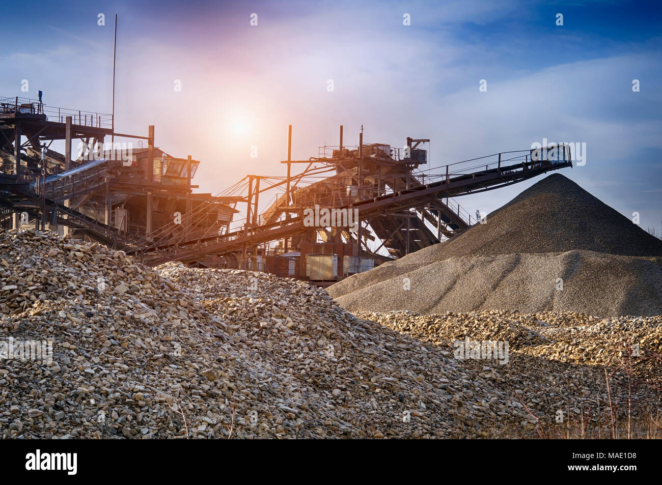 conveyors in a stone quarry at sunset Stock Photo - Alamy