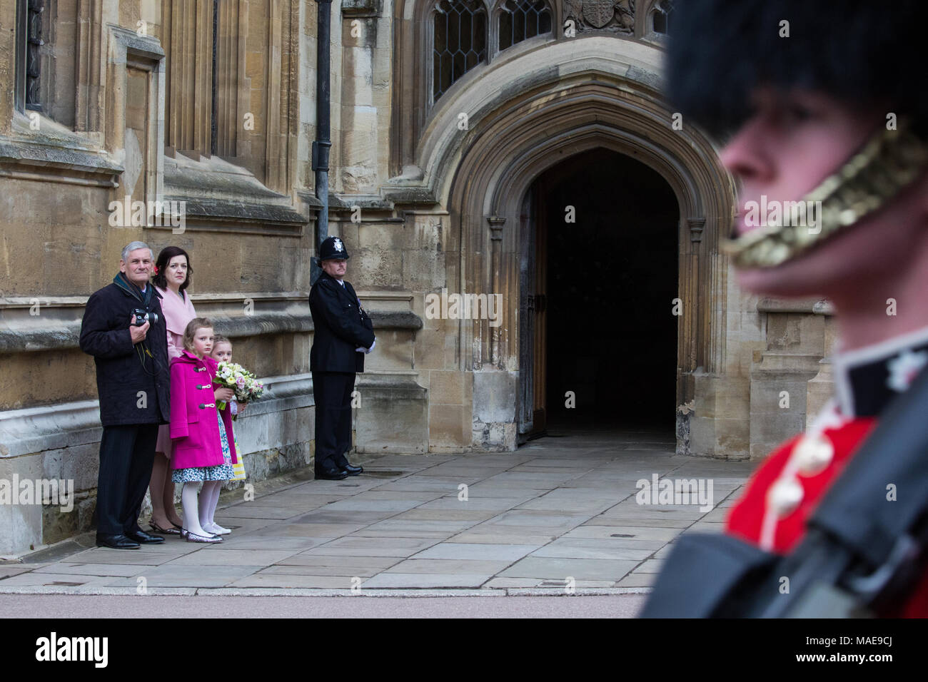 Windsor, UK. 1st April, 2018. A guard passes Madeleine Carleston and ...