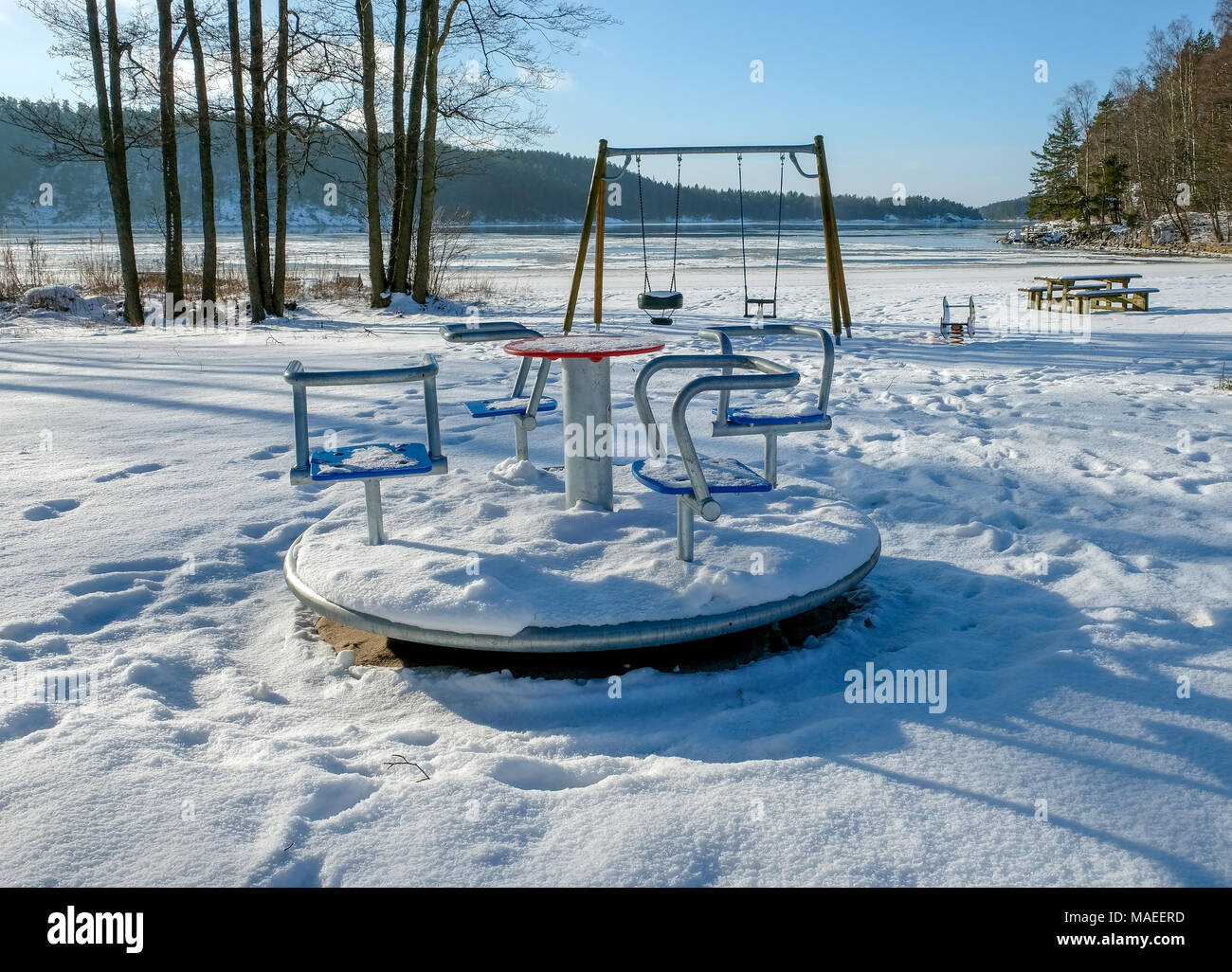 playground in winter with snow and sun Stock Photo - Alamy