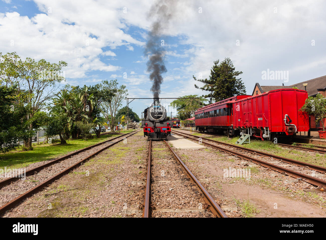 Steam train locomotive with passenger coaches closeup exhuasts pulls ...