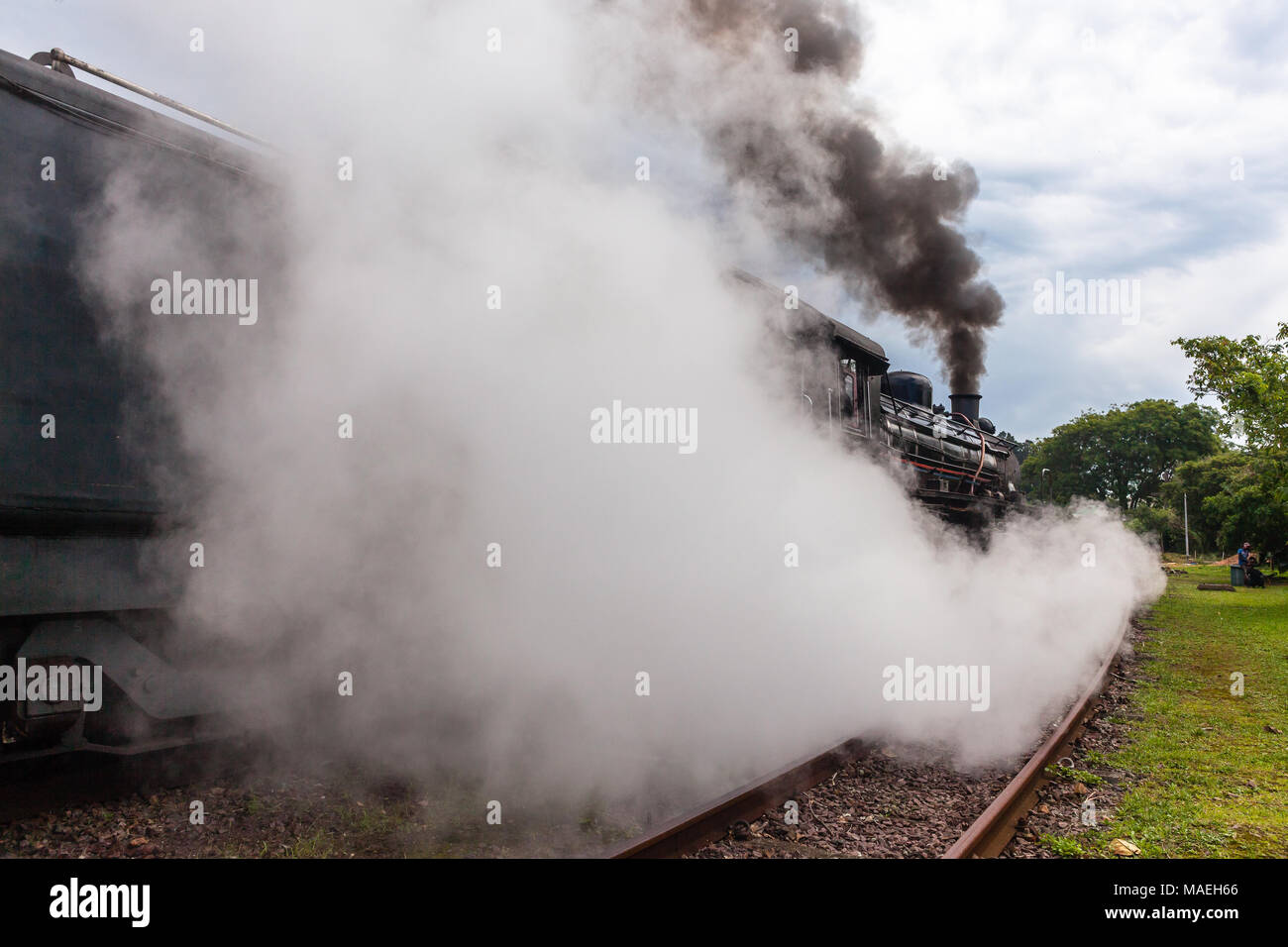 Steam train locomotive closeup exhuasts pulls out of countryside ...