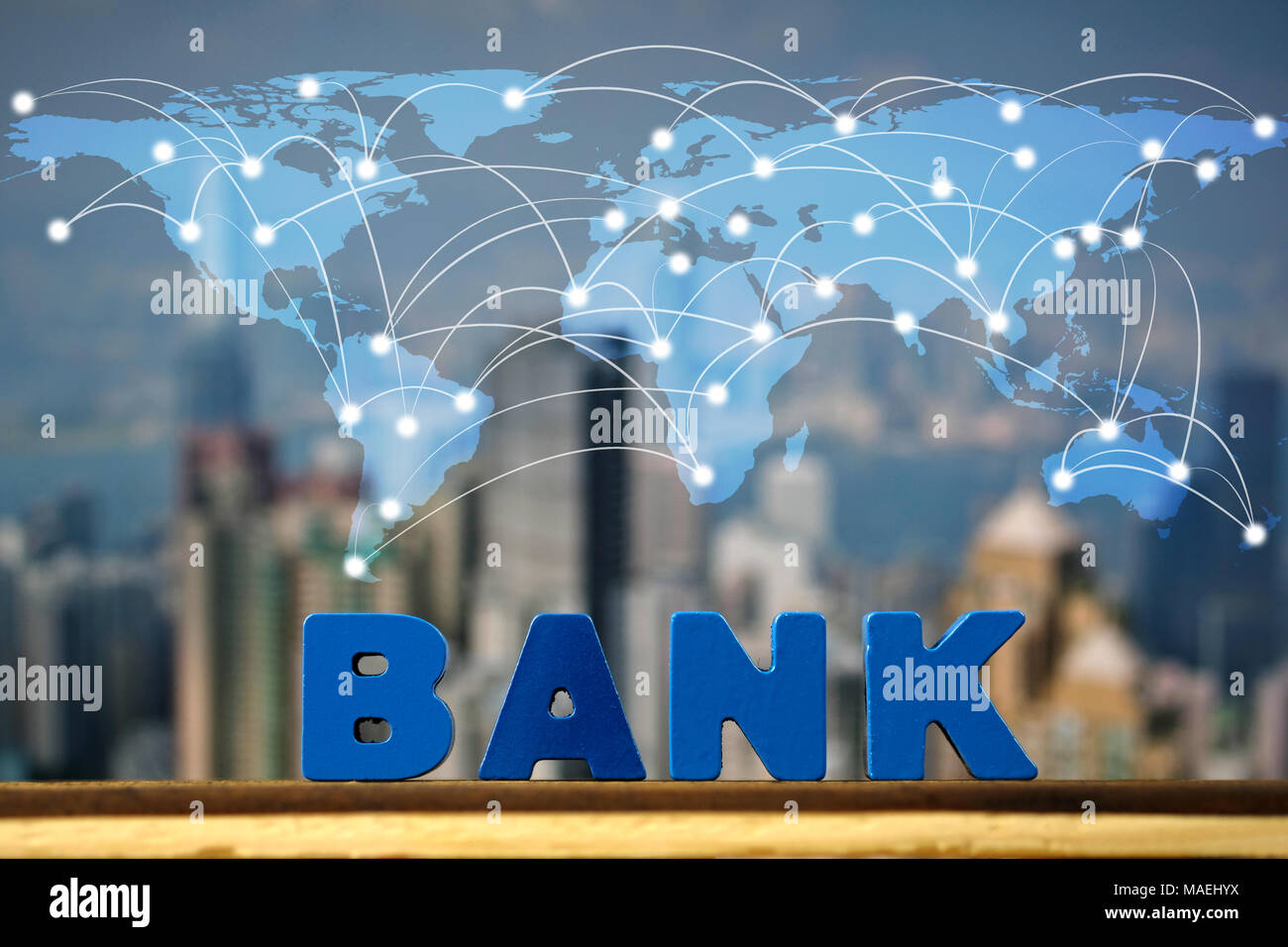 BANK text on top wooden working table with city background and world ...