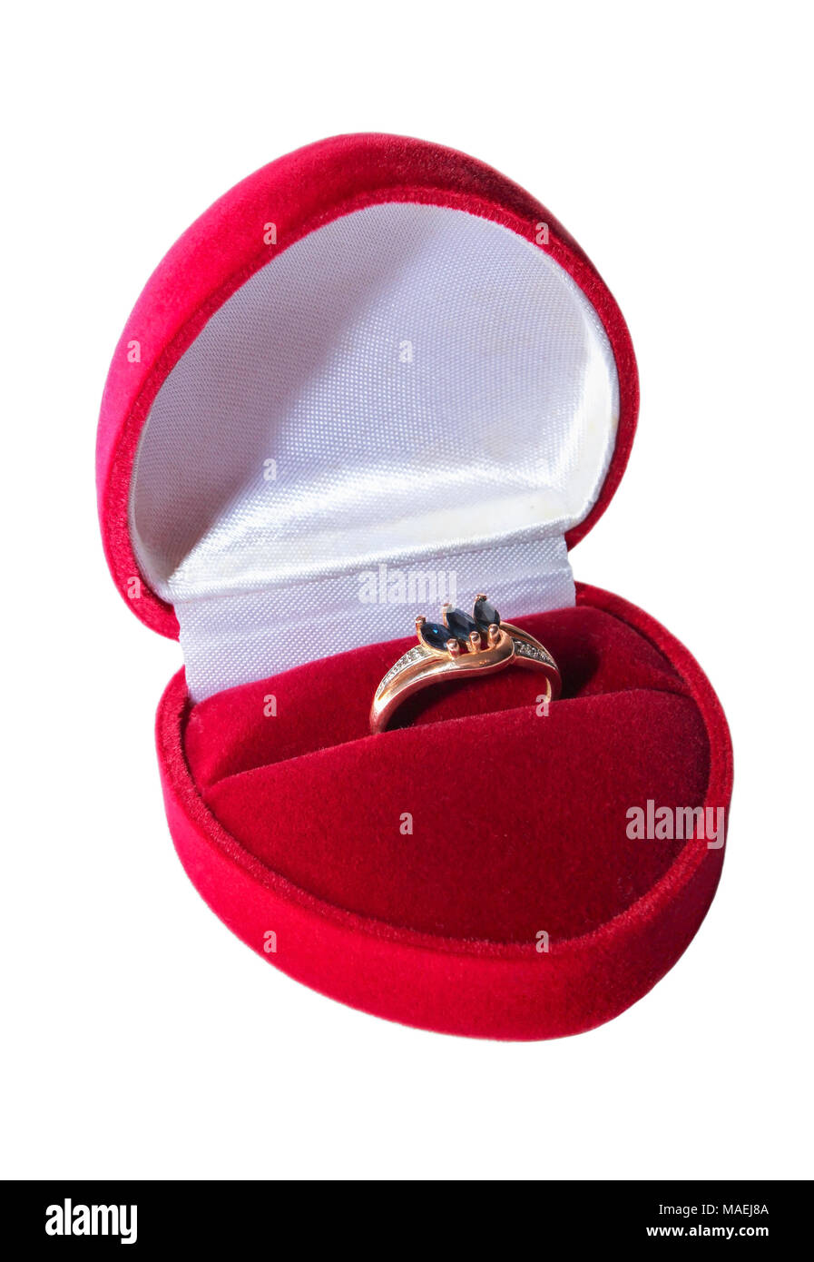 Gold ring with sapphires in a red velvet box on a white background ...