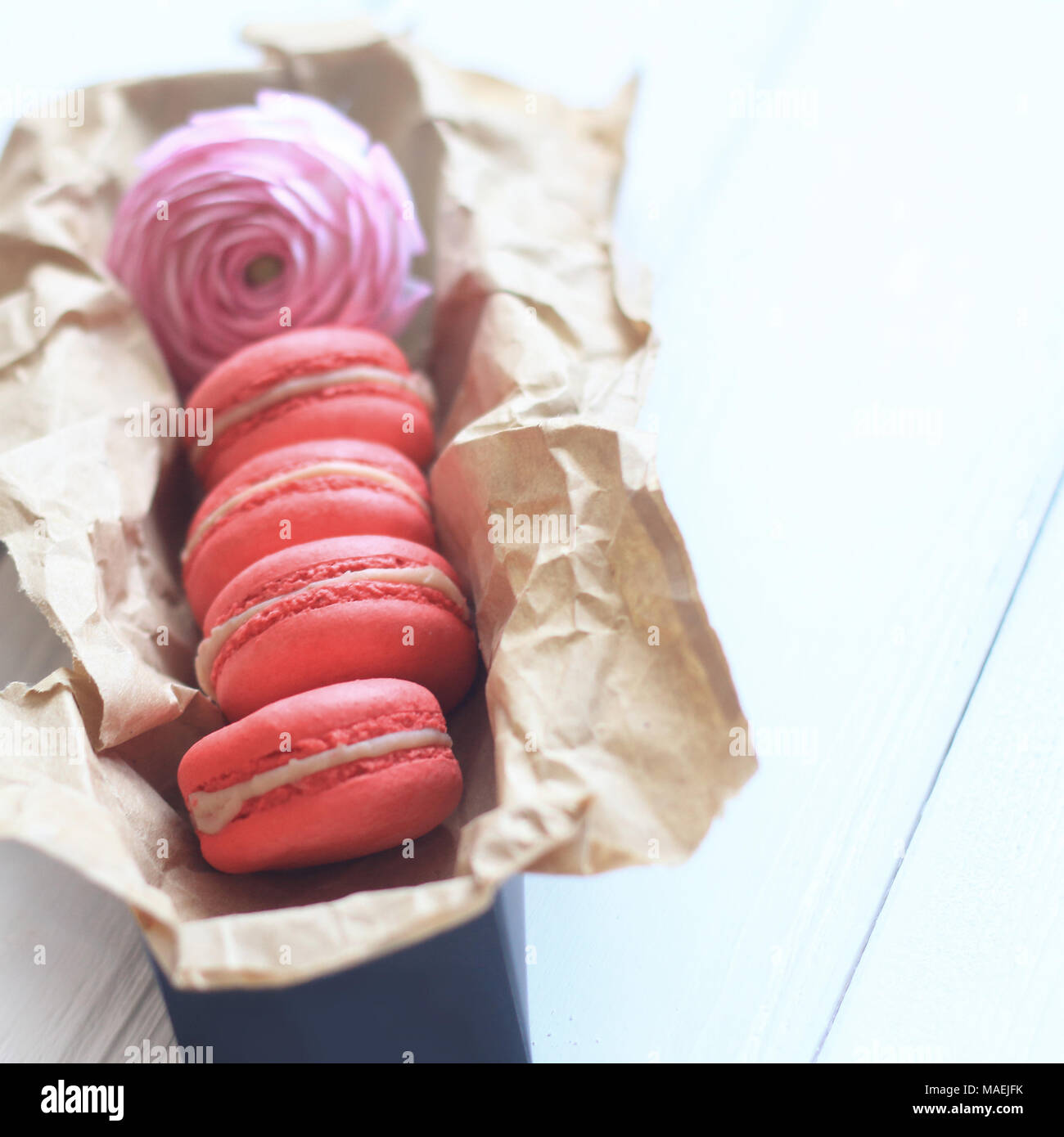 Colorful macaroons and flowers on table Stock Photo - Alamy