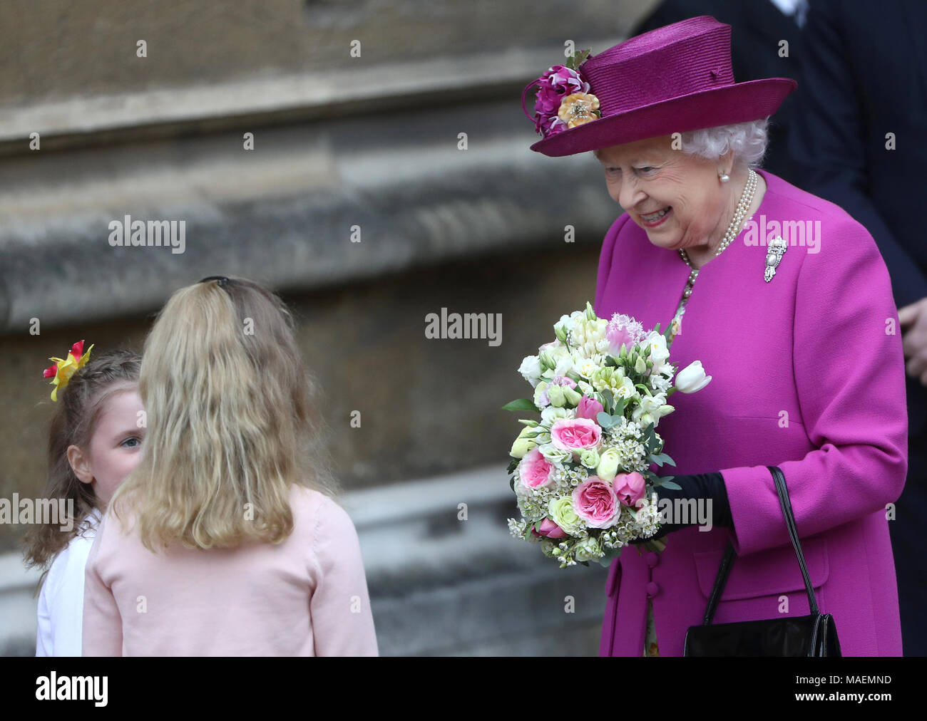 Queen Elizabeth II is handed a posey as she leaves following the Easter ...
