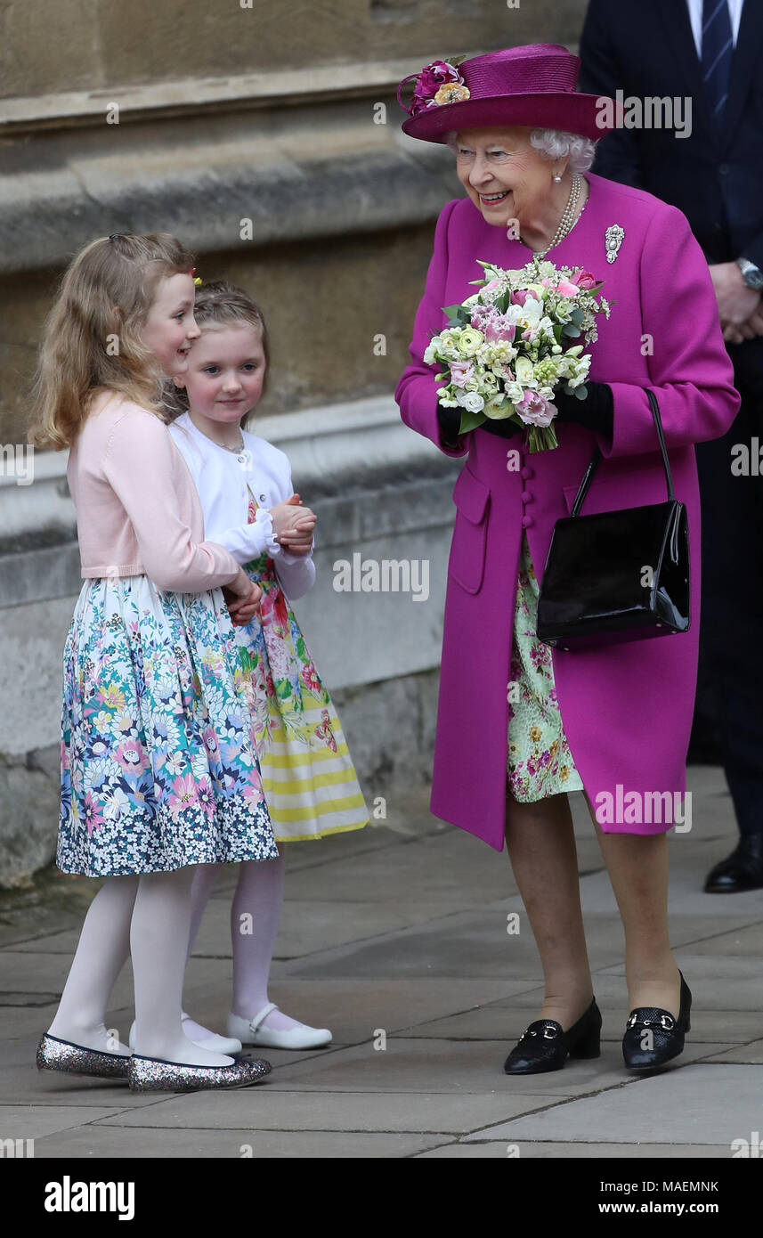 Queen Elizabeth II is handed a posey as she leaves following the Easter ...