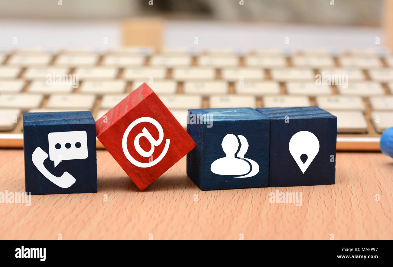 Contact Us communication Icons on wooden dice and keyboard Stock Photo - Alamy