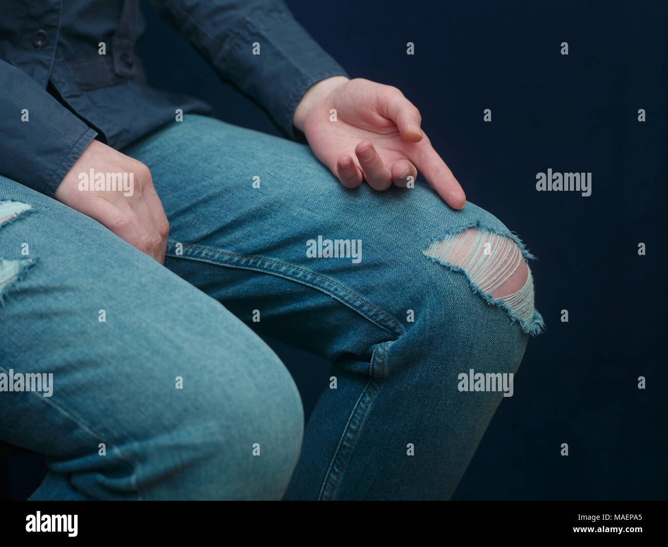 Woman in torn jeans hi-res stock photography and images - Alamy