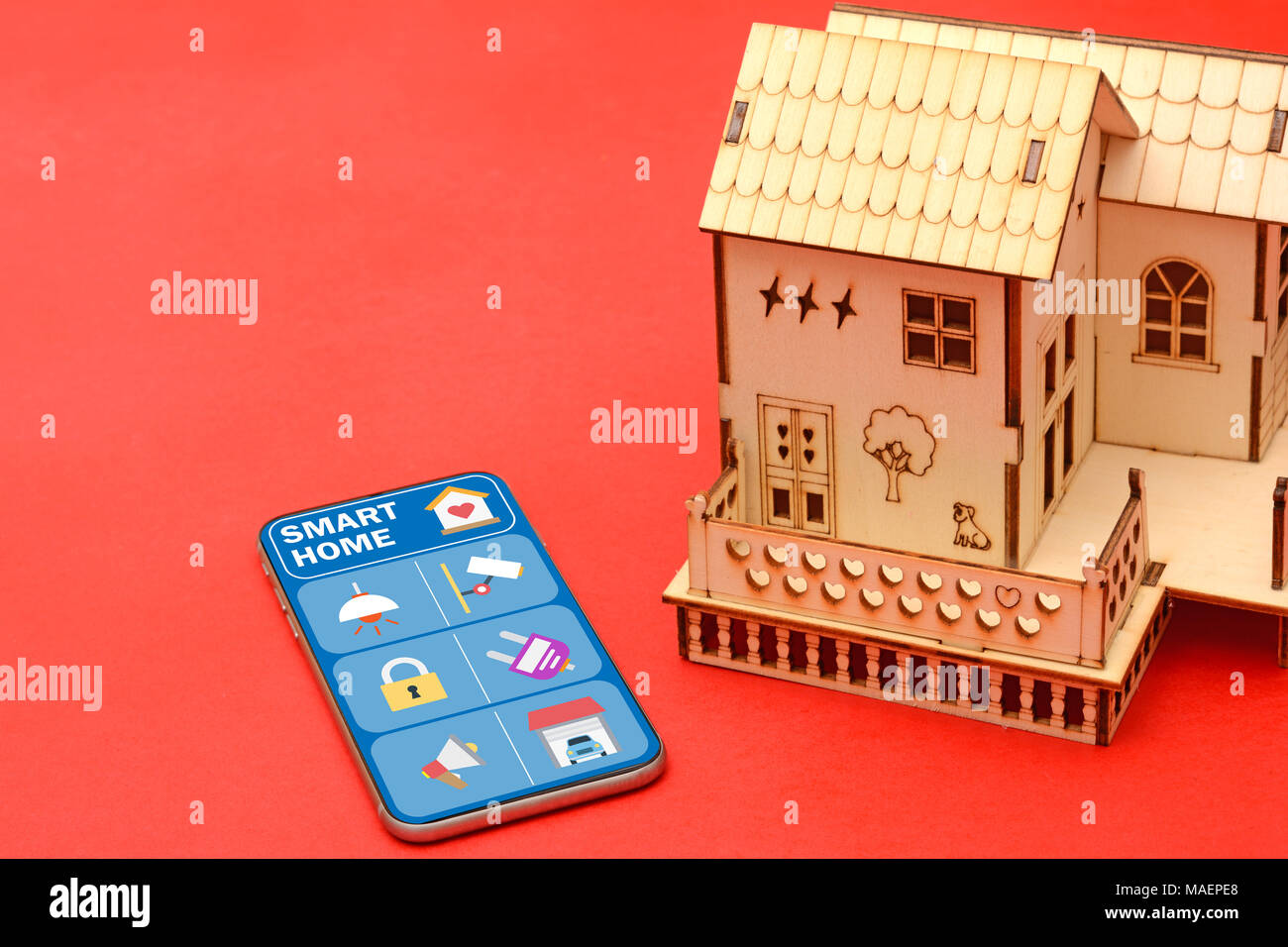 Smart home mobile screen with house miniature Stock Photo - Alamy