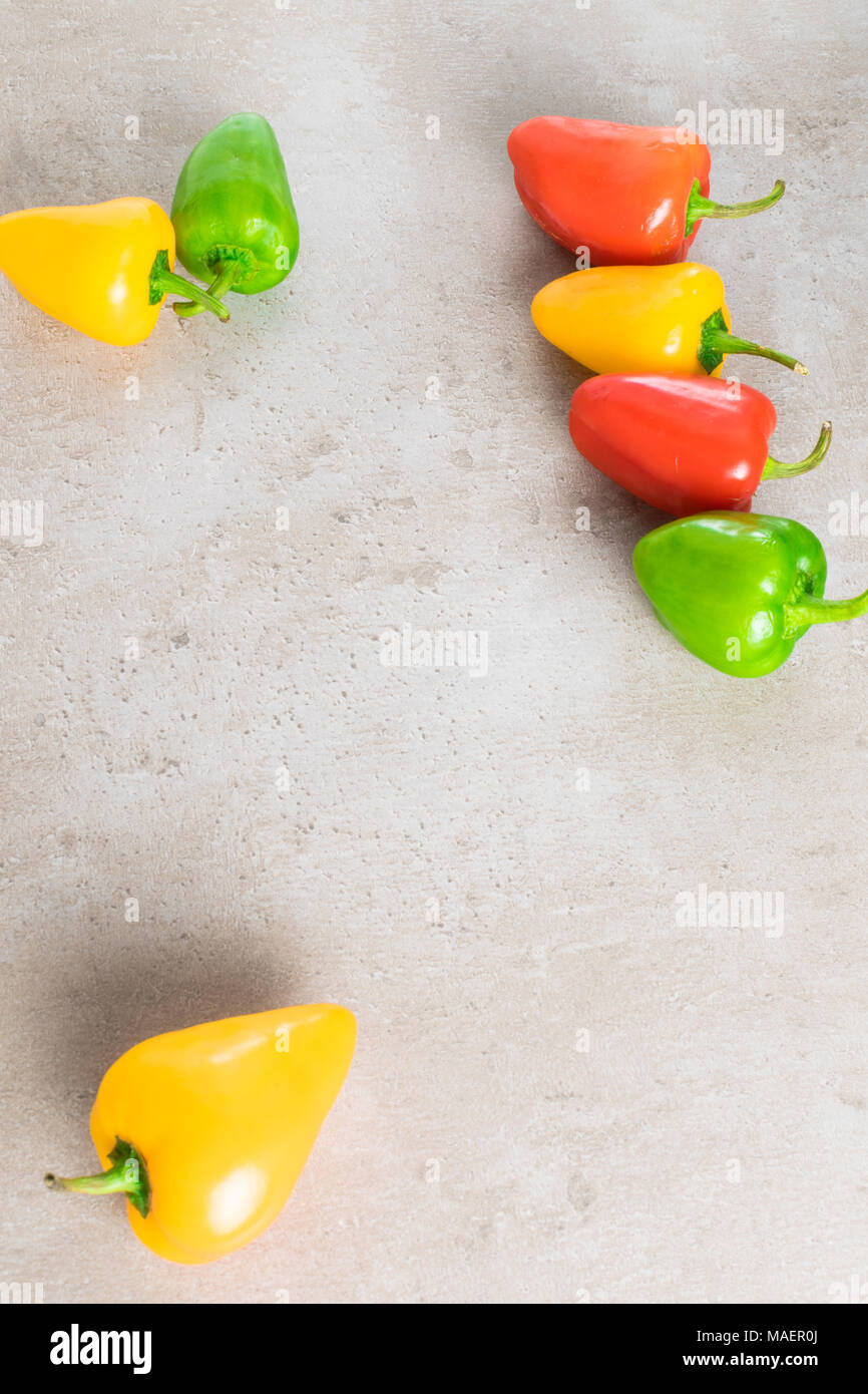 raw organic mini sweets color peppers on grey table Stock Photo - Alamy