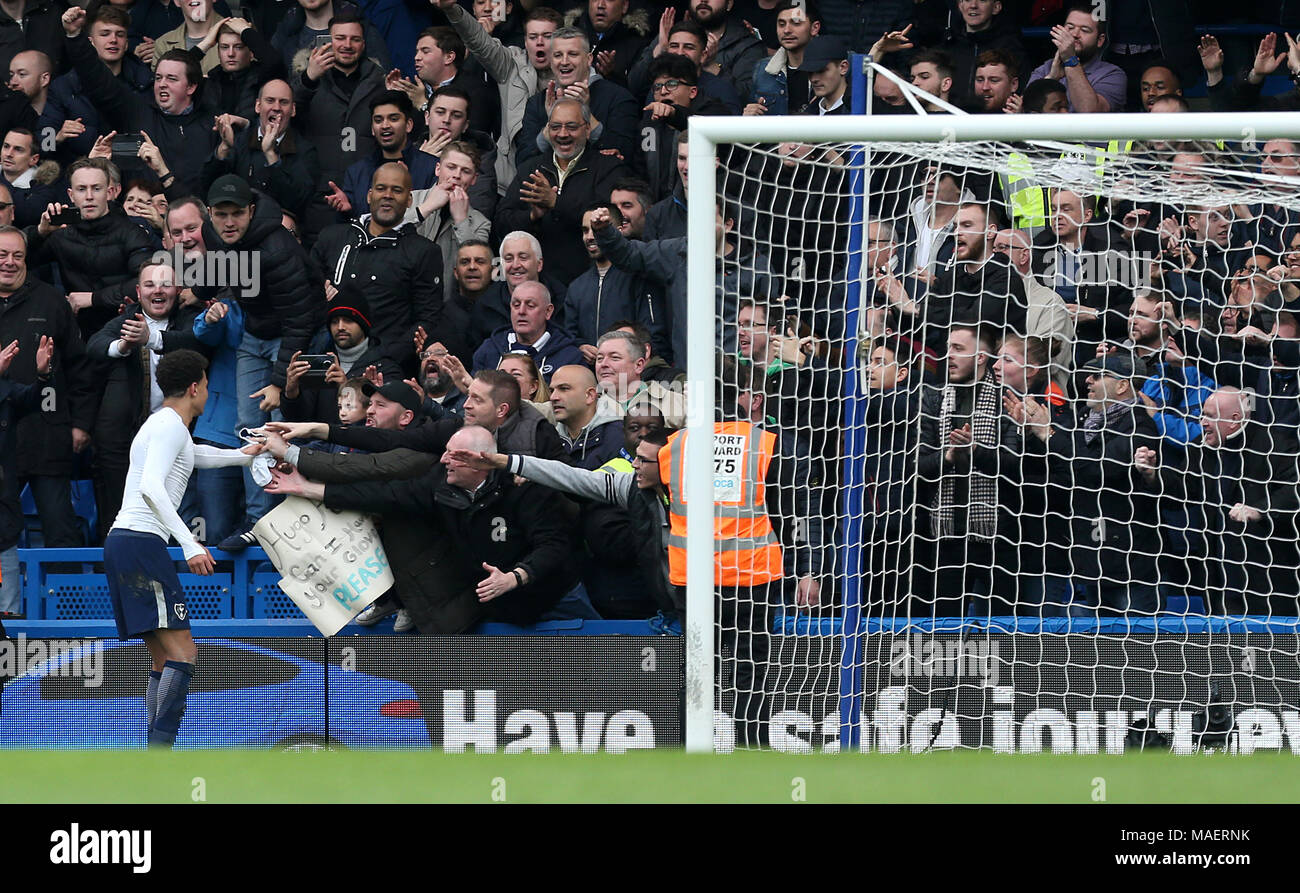 Tottenham Hotspur's Dele Alli (left) gives his strip to a young fan ...