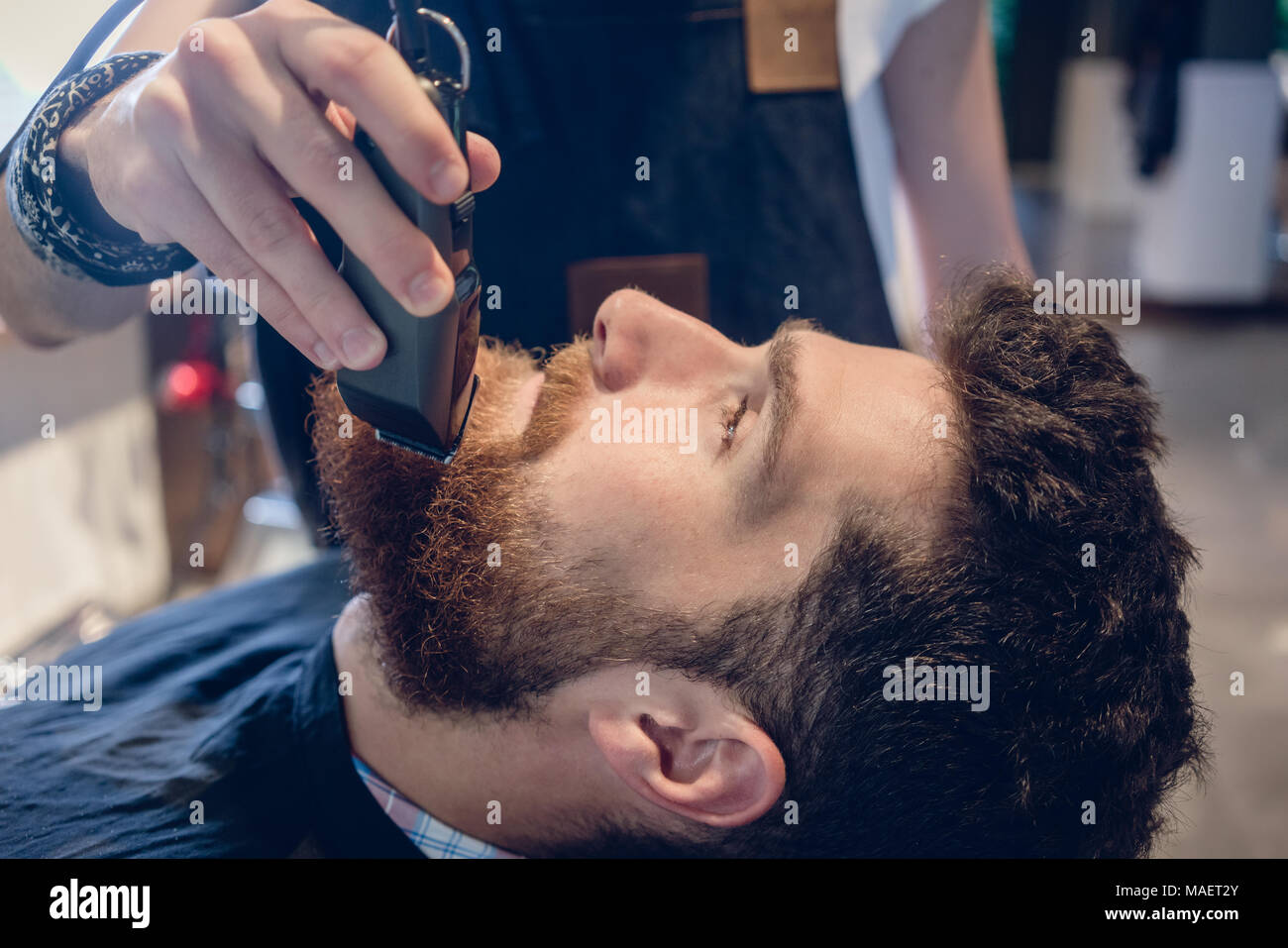 Barber trimming man hi-res stock photography and images - Alamy