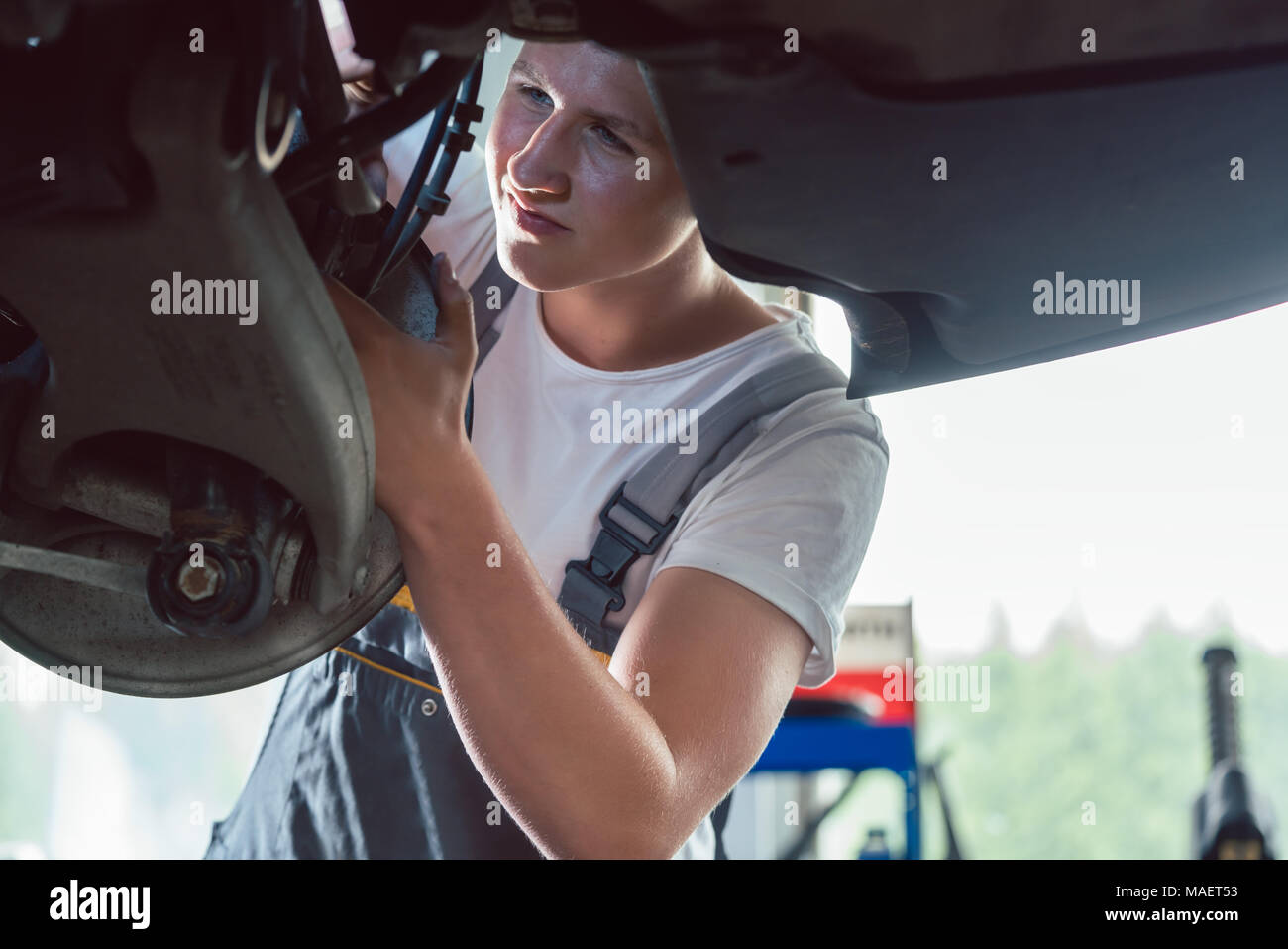 Dedicated mechanic working in a modern automobile repair shop Stock ...