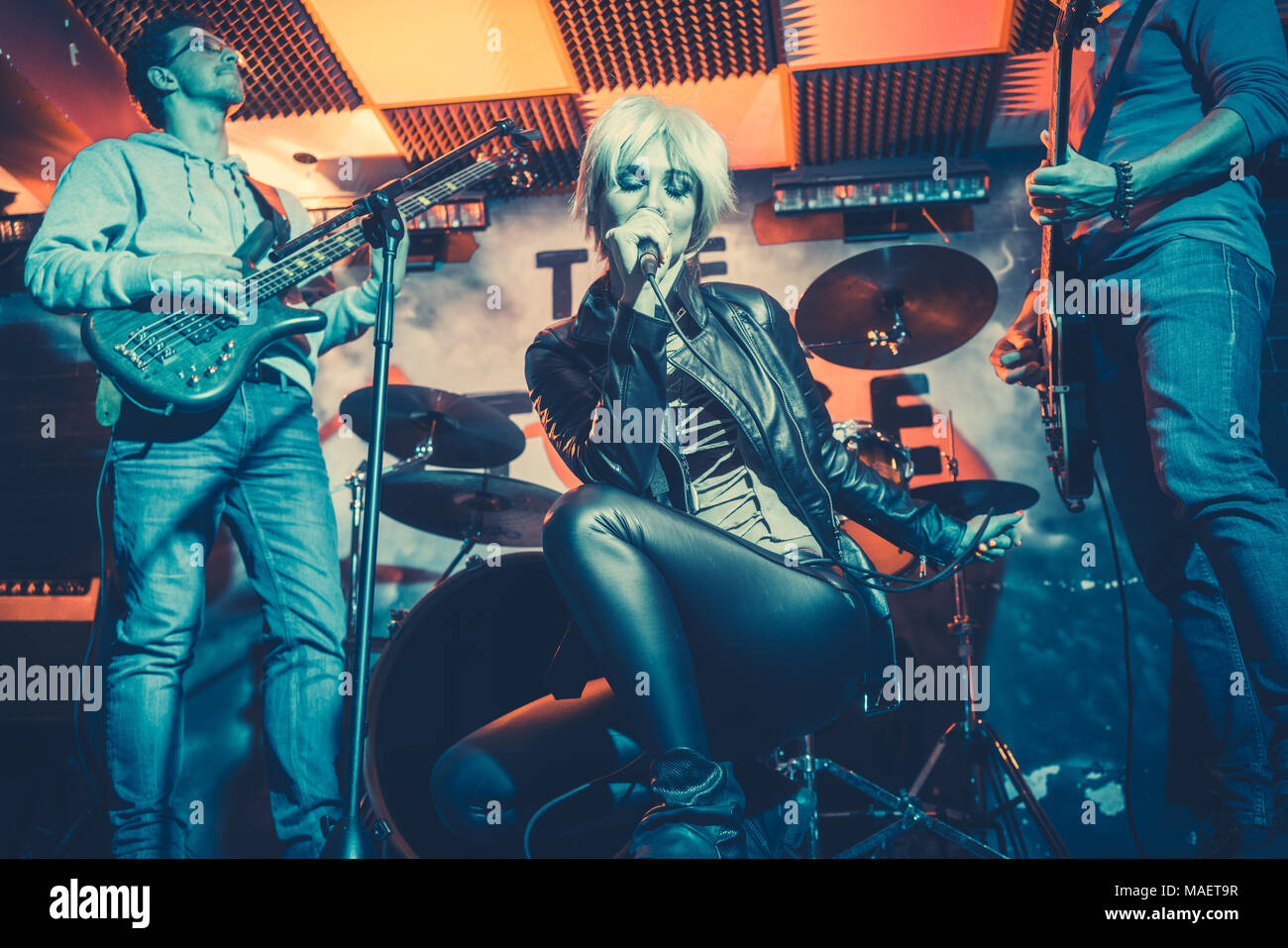 Band playing on stage making music Stock Photo - Alamy