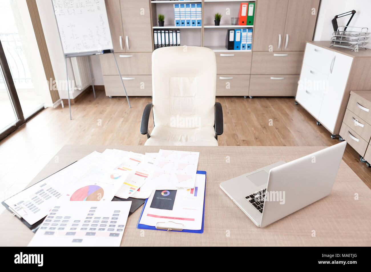 Table in an office with diagrams on it Stock Photo - Alamy