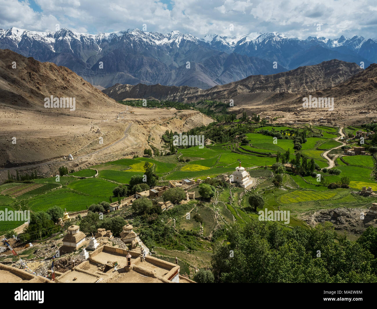Mountain Tibetan village: among the high chains of ridges with snowy ...