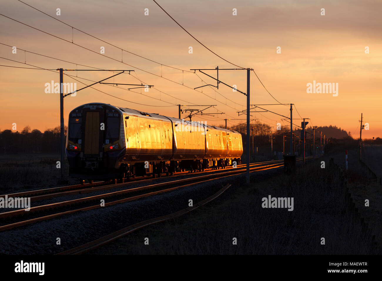 Scotrail class 380 electric train glinting in the sunset 380106 passes ...