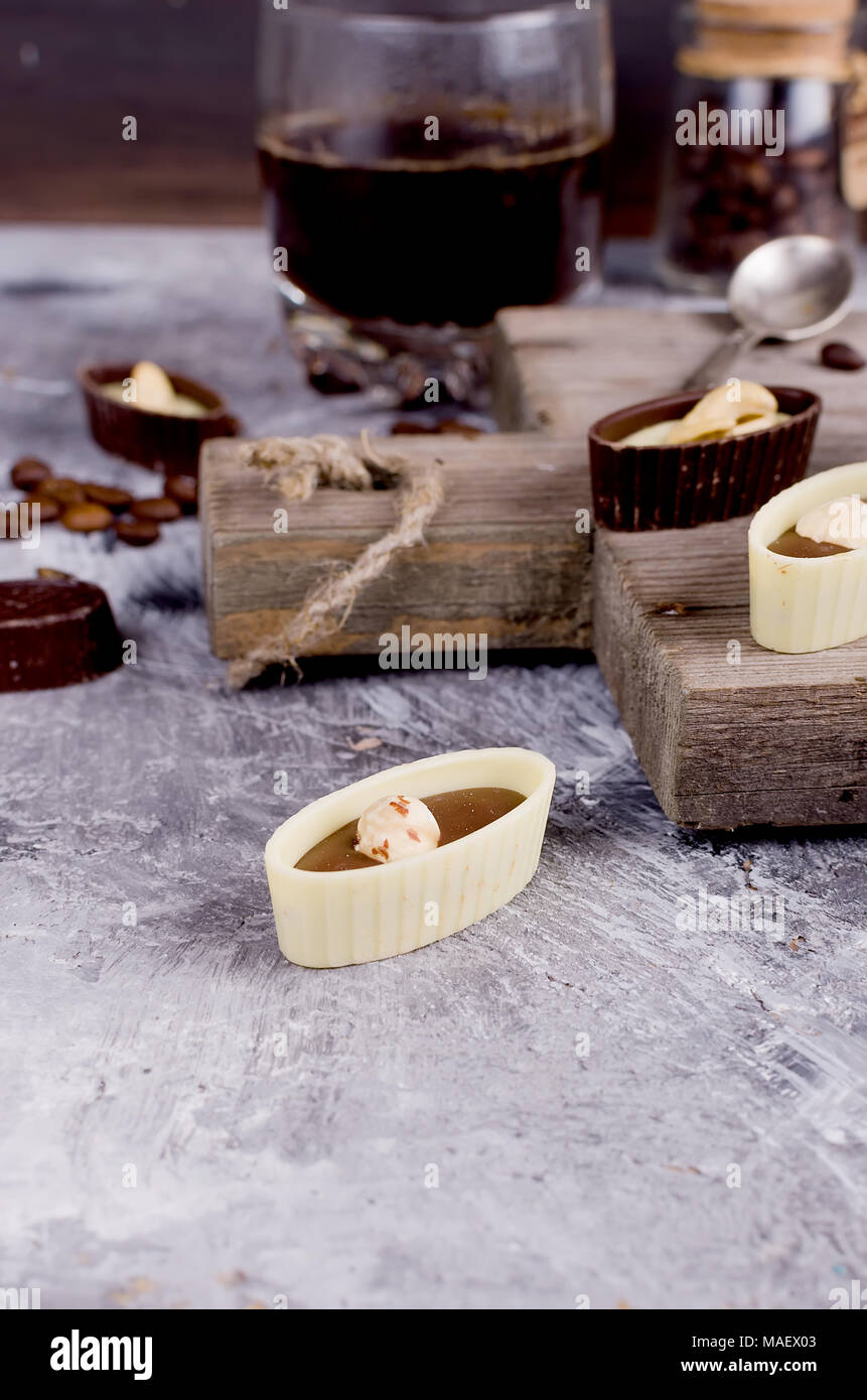 chocolate candy boat with nut on a concrete background dessert for ...