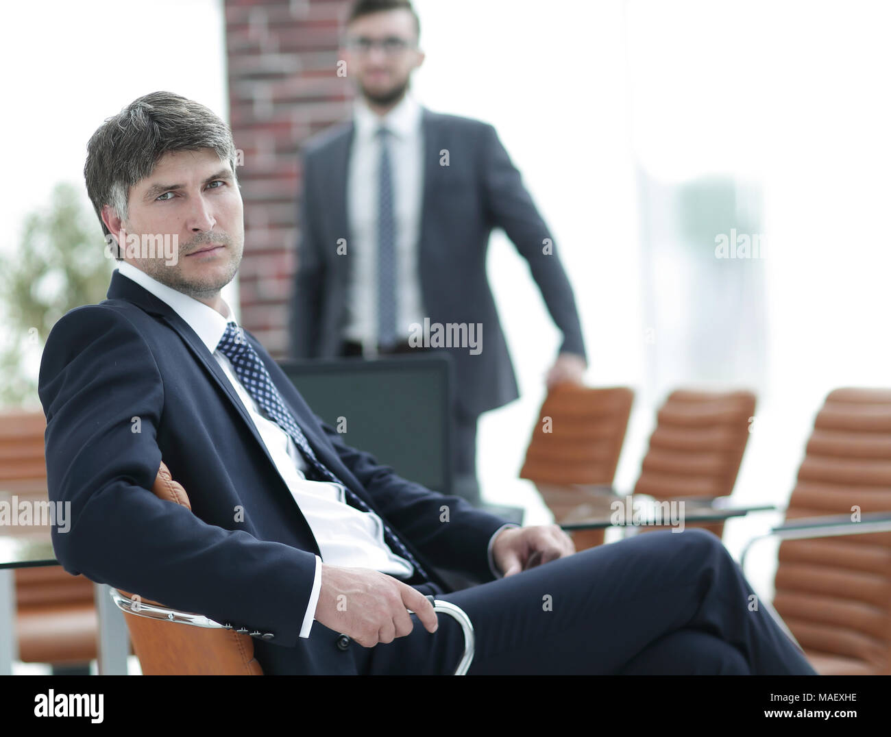 Businessman sitting in an empty conference room Stock Photo - Alamy