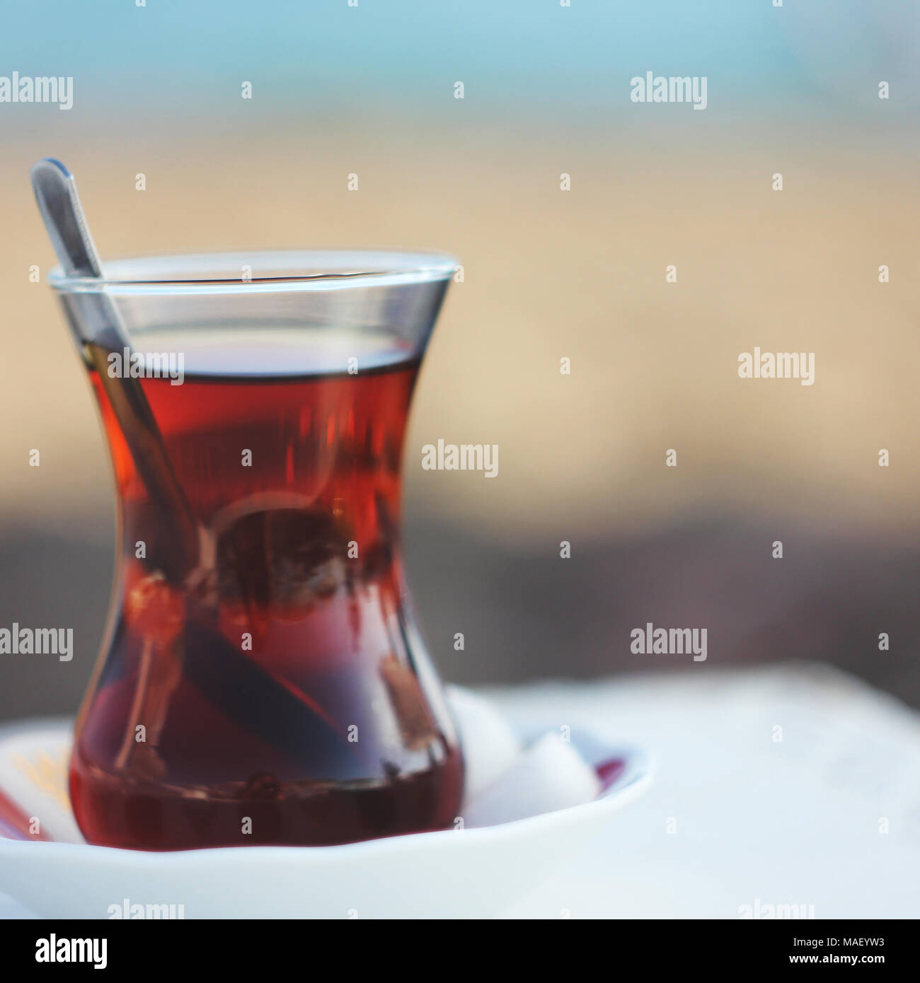 Black herbal turkish tea in traditional glass at the street cafe on ...