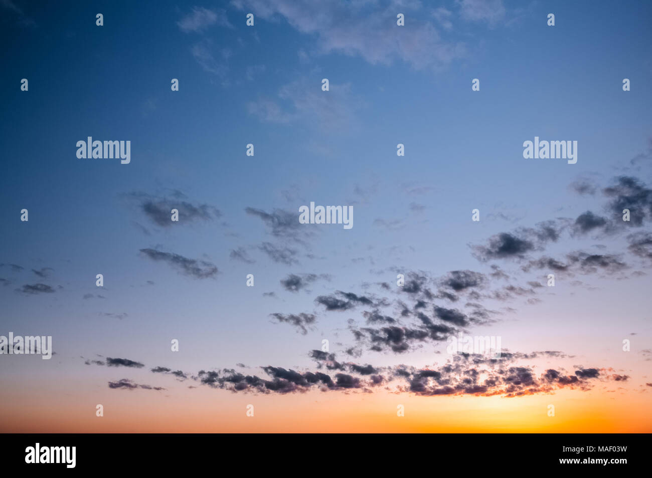 Sunset evening sky with sparse clouds background Stock Photo - Alamy