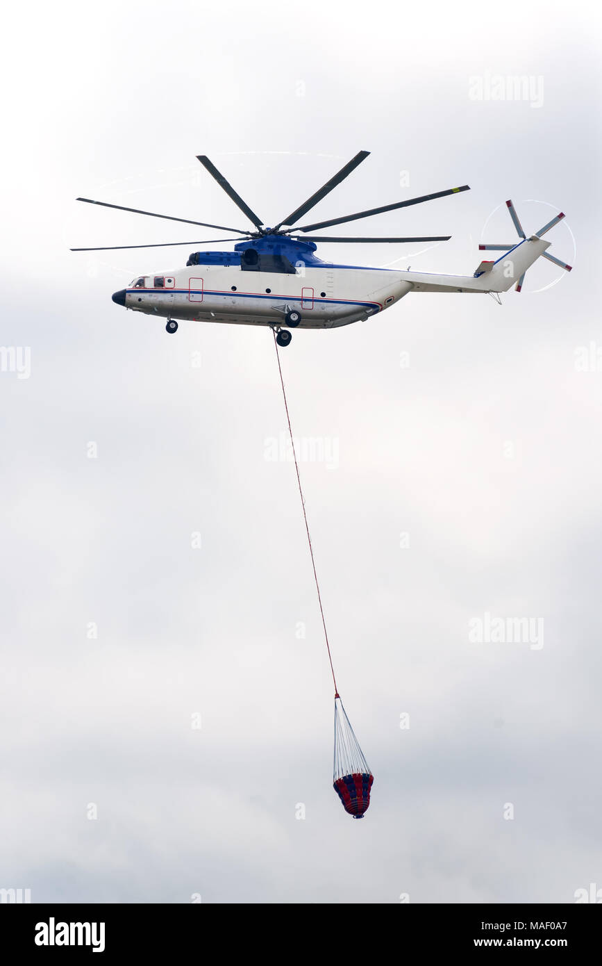 Fire helicopter flies in sky and has a water tank for fire fighting ...