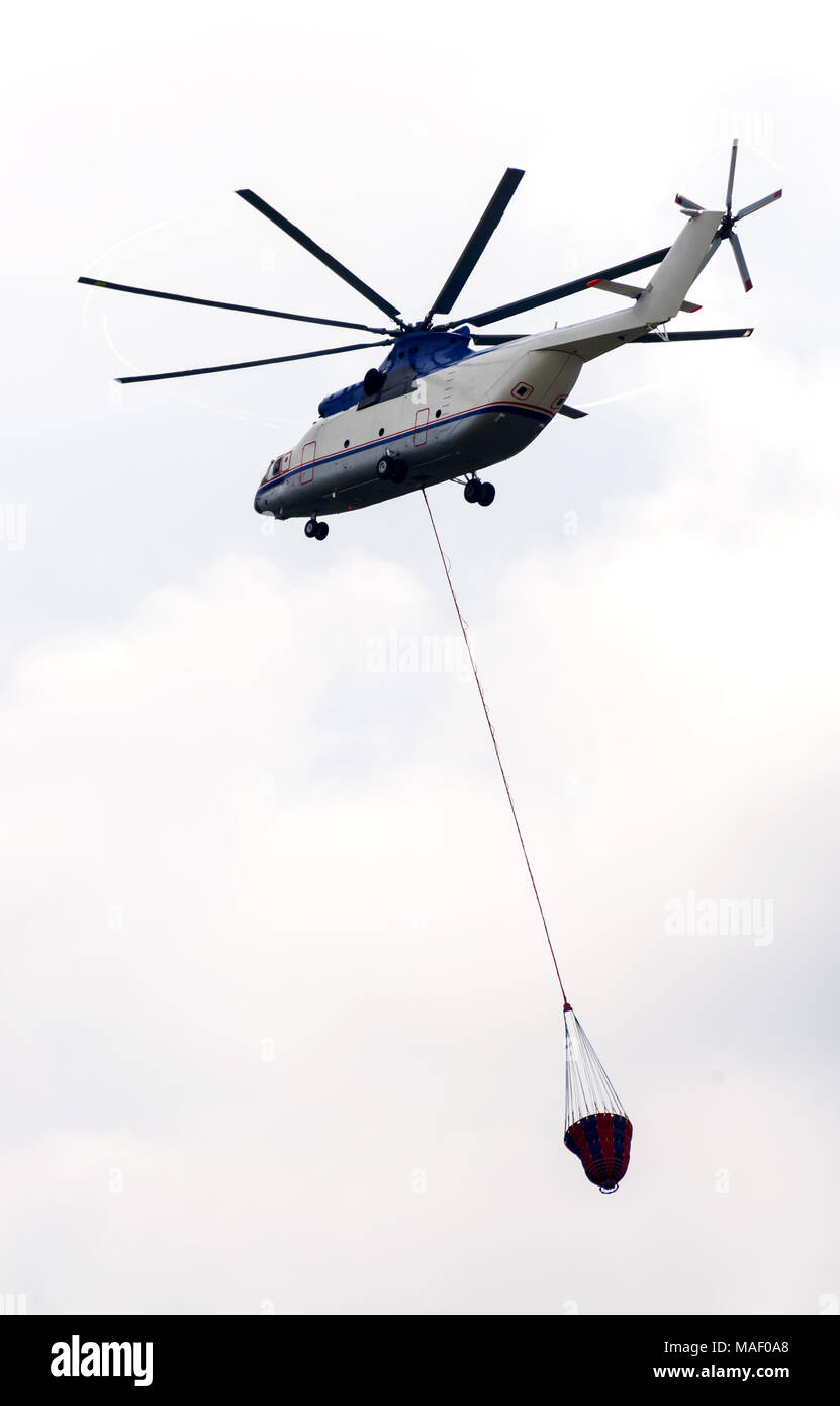 Fire helicopter flies in sky and has a water tank for fire fighting ...