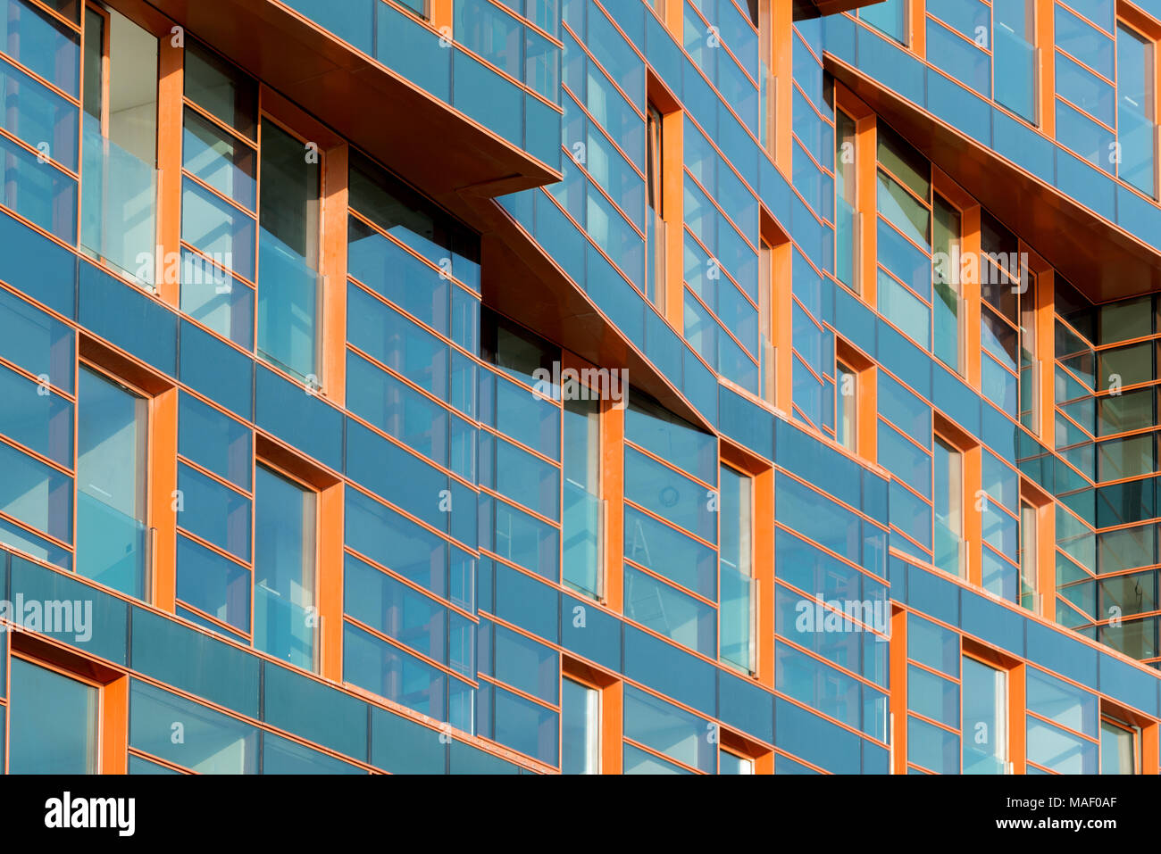 A modern building mirror facade in blue tone Stock Photo - Alamy