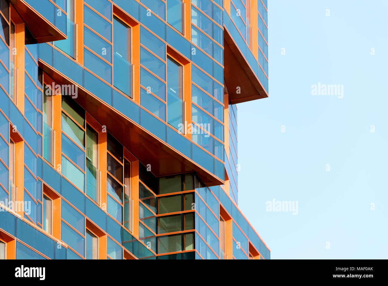 A modern building mirror facade in blue tone Stock Photo - Alamy