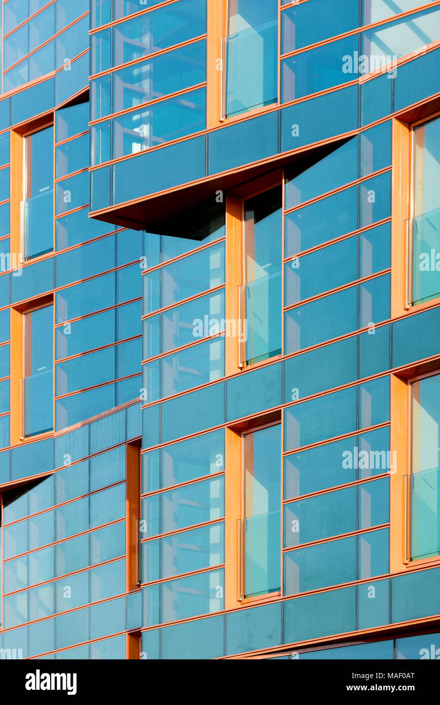 A modern building mirror facade in blue tone Stock Photo - Alamy