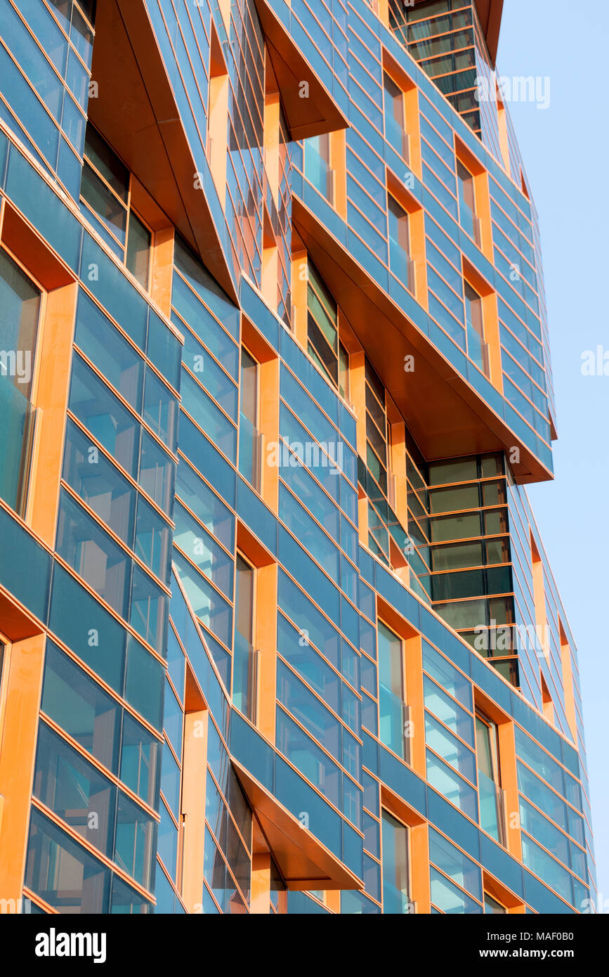 A modern building mirror facade in blue tone Stock Photo - Alamy