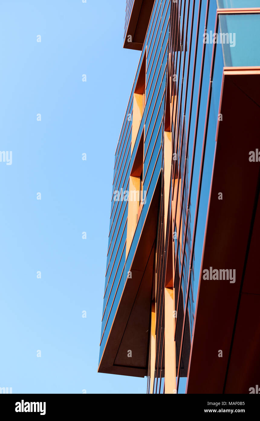 A modern building mirror facade in blue tone Stock Photo - Alamy