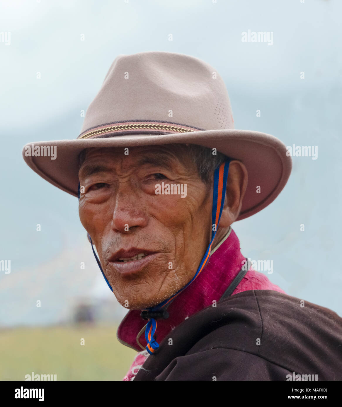 Tibetan man in traditional clothing at Horse Race Festival, Litang ...