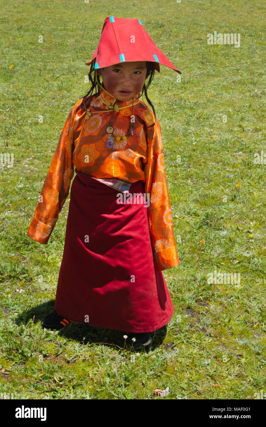 Tibetan boy in traditional clothing at Horse Race Festival, Litang ...