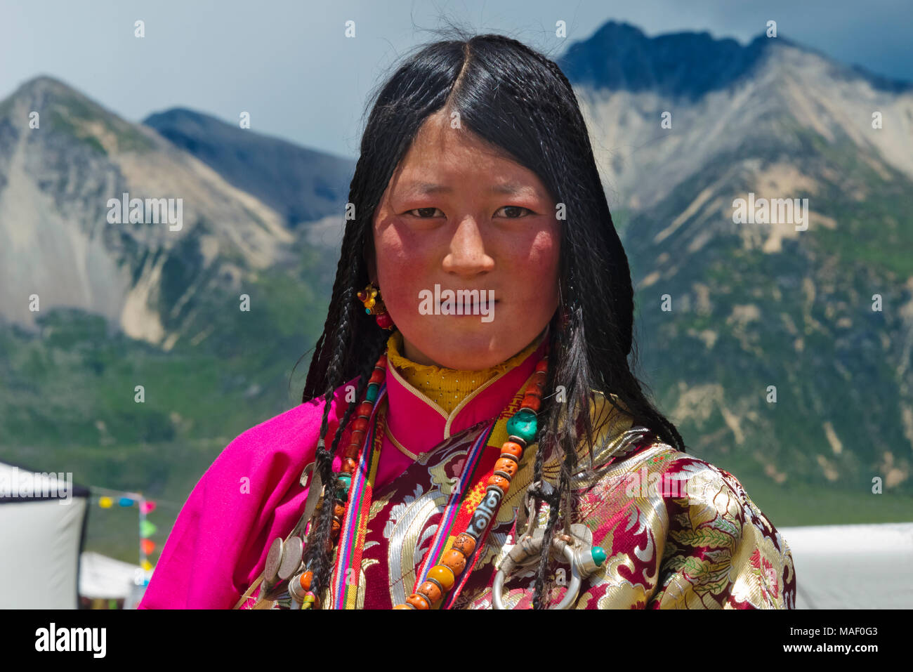 Tibetan woman in traditional clothing at Horse Race Festival, Litang ...