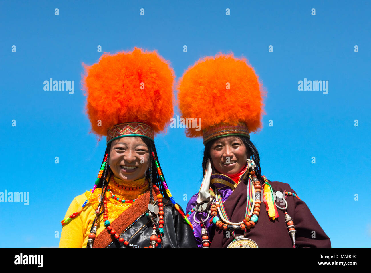 Tibetan women in traditional clothing at Horse Race Festival, Litang ...