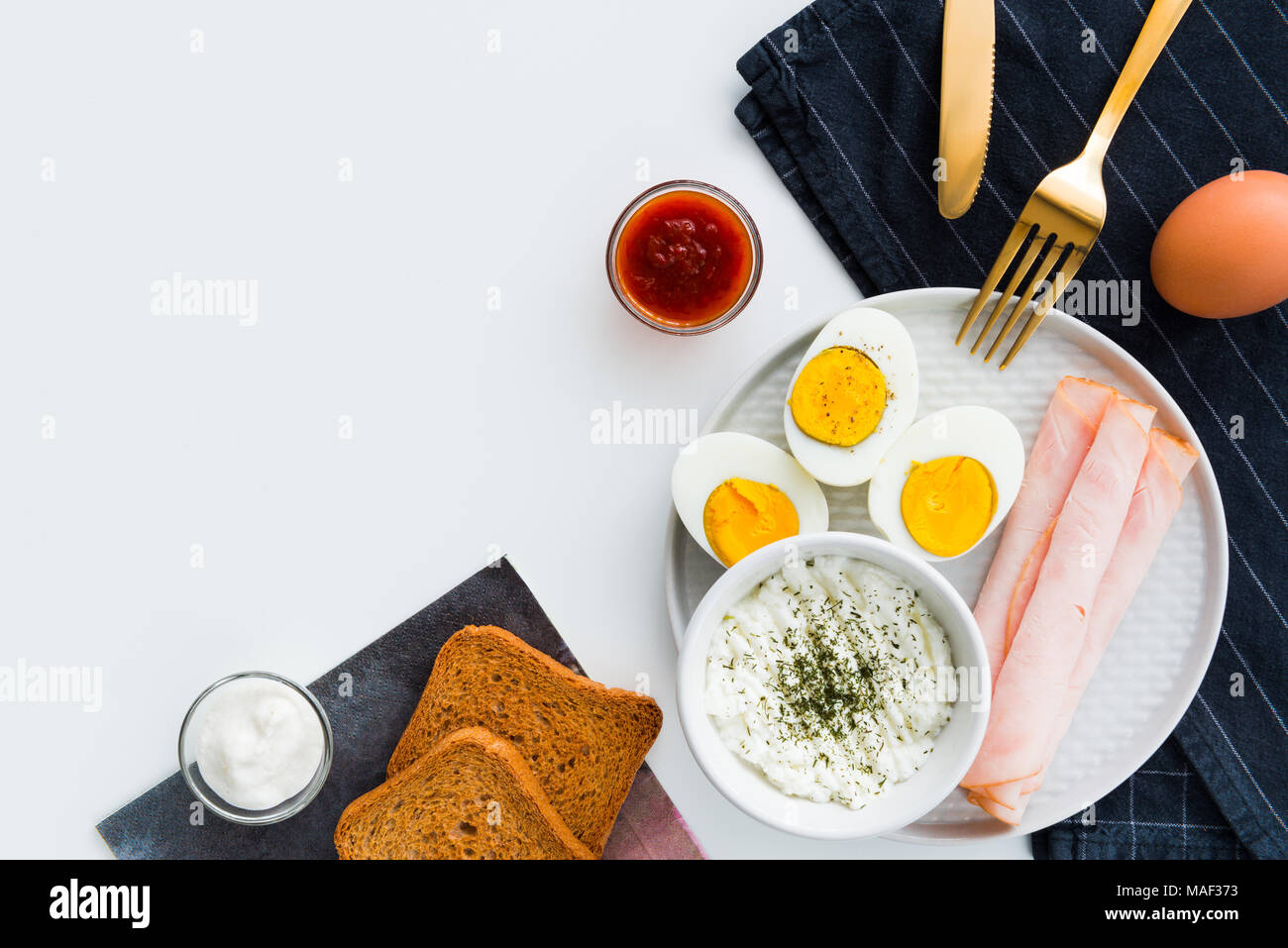 Breakfast, half boiled eggs, ham, fresh cheese sprinkled with dill ...