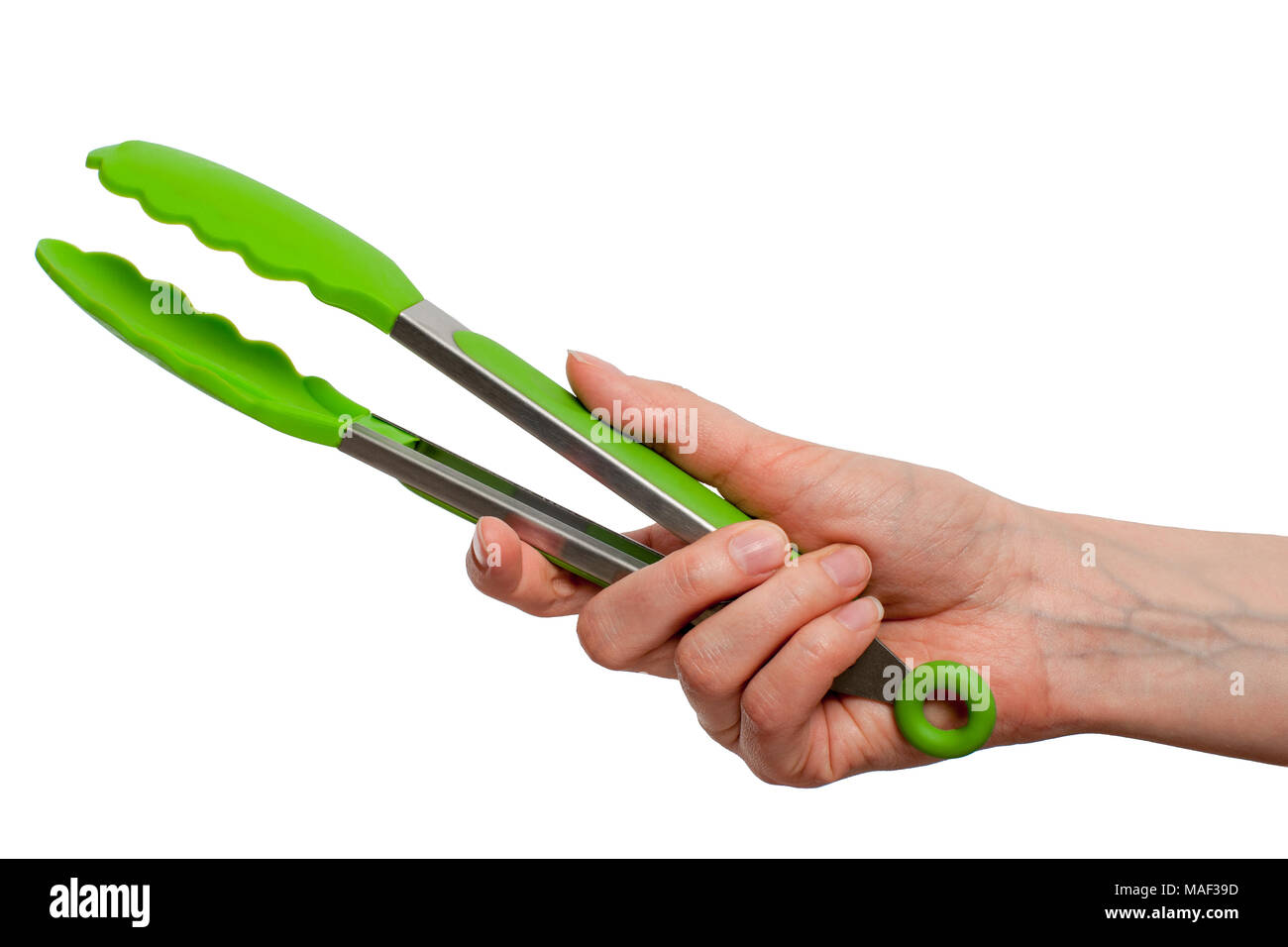 hand with metal kitchen tongs with green silicone details isolated on ...